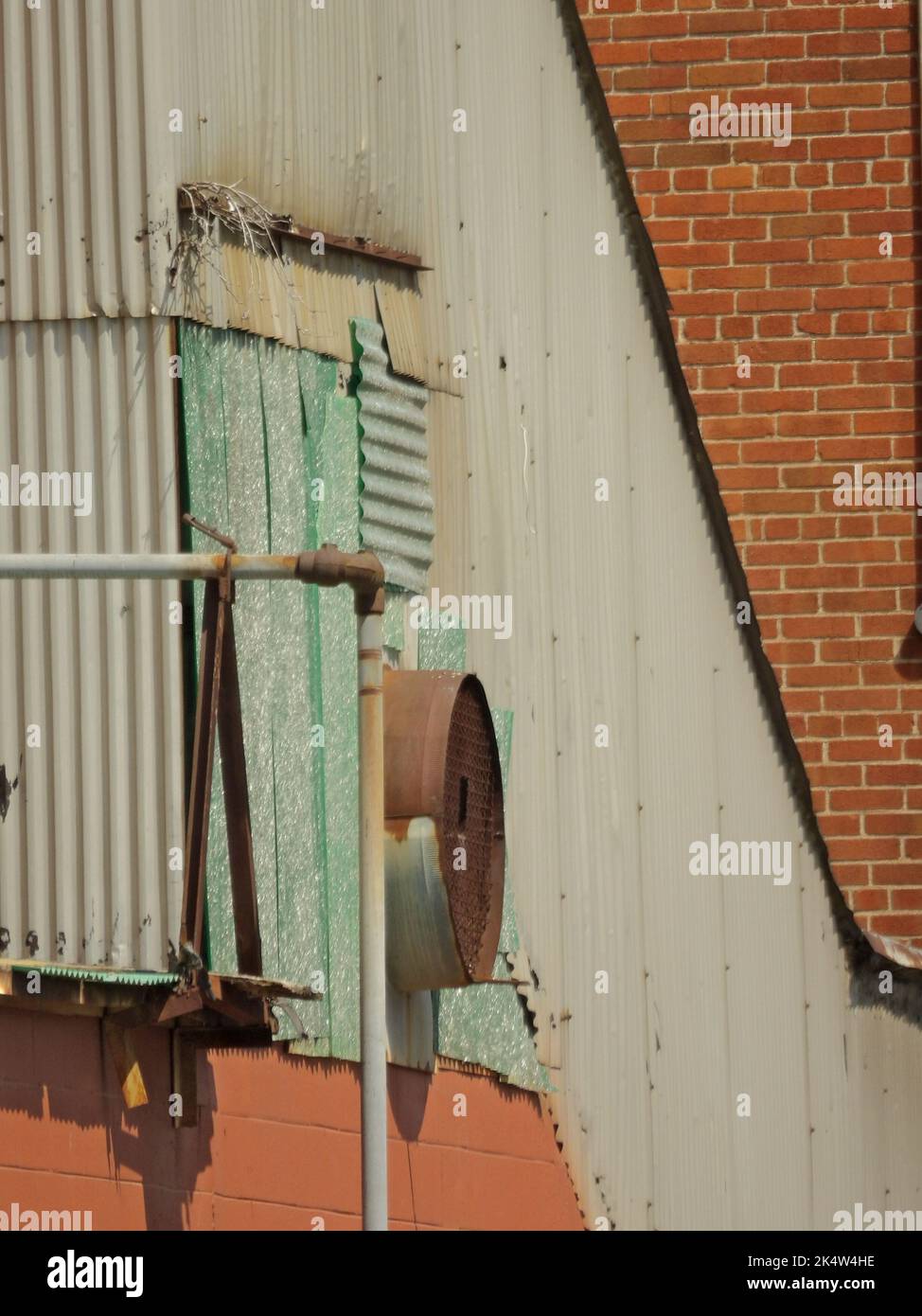 A closeup of ventilation tube mounted on old brick building wall Stock ...