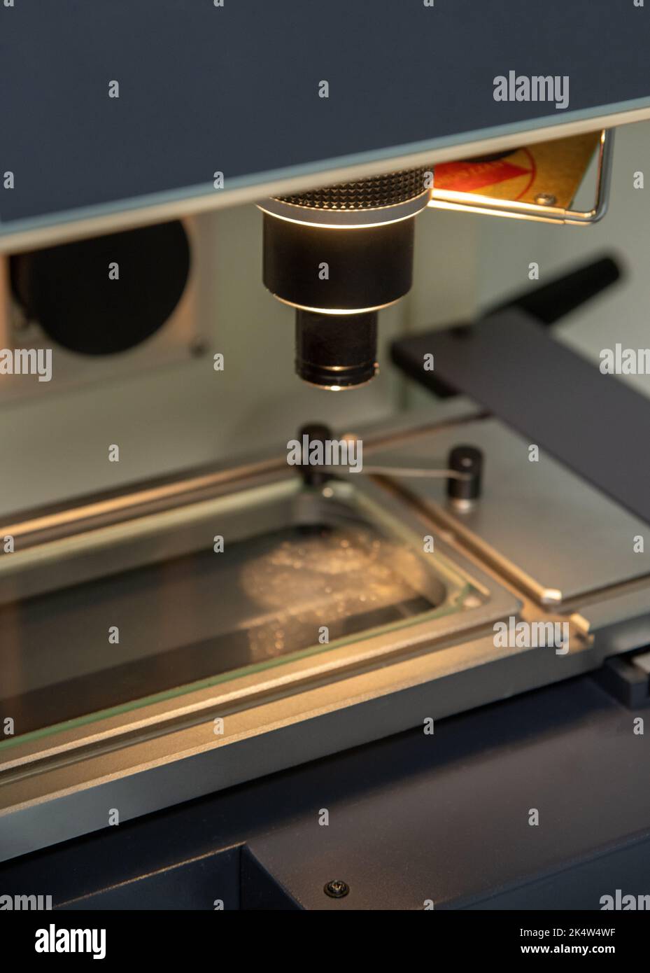 A vertical closeup shot of an illuminated microscope at a medical ...