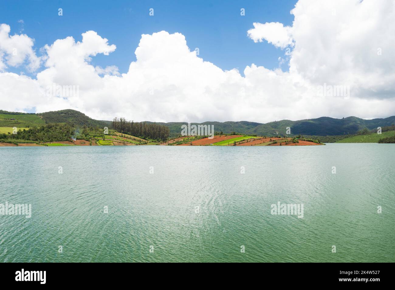 Scenic Ooty Lake, blue and white sky, reflection visible in water ...