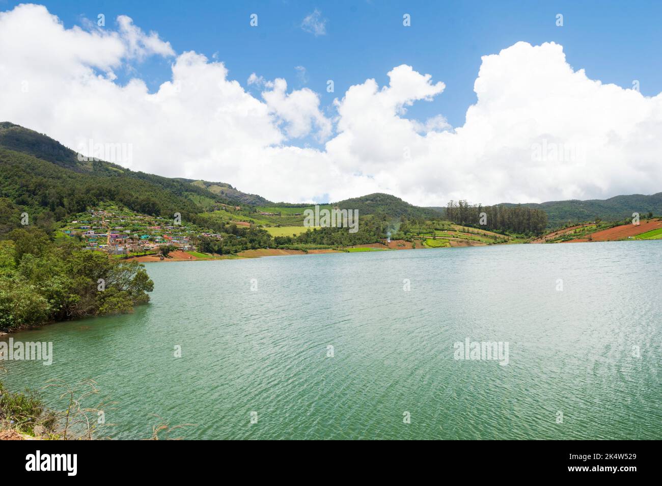 Scenic Ooty Lake, blue and white sky, reflection visible in water ...