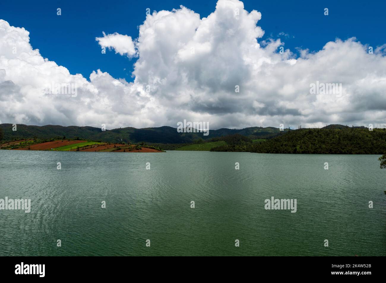 Scenic Ooty Lake, blue and white sky, reflection visible in water ...