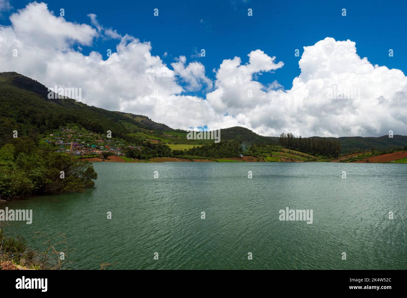 Scenic Ooty Lake, blue and white sky, reflection visible in water ...