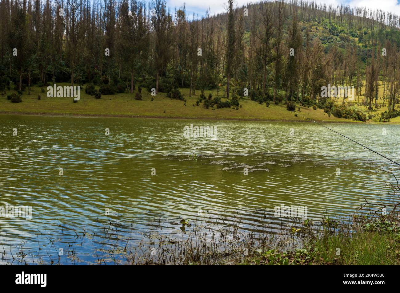 Scenic Ooty Lake, blue and white sky, reflection visible in water ...