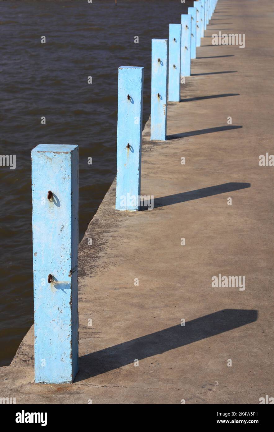 Concrete pole with chains hooks on jetty, Blue Jetty pole, Blue ...