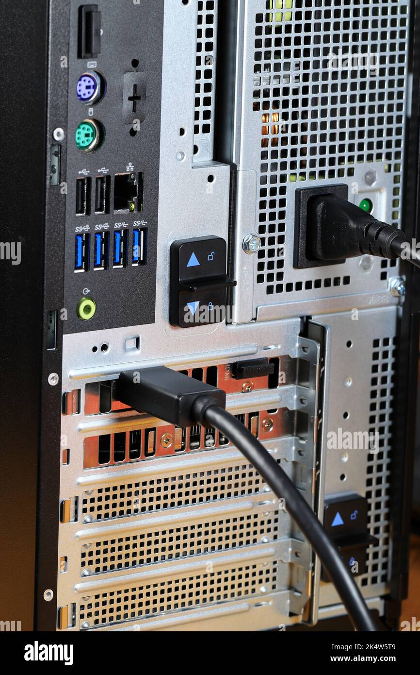 Close up of AC power and display port cable plugged into the back of ...