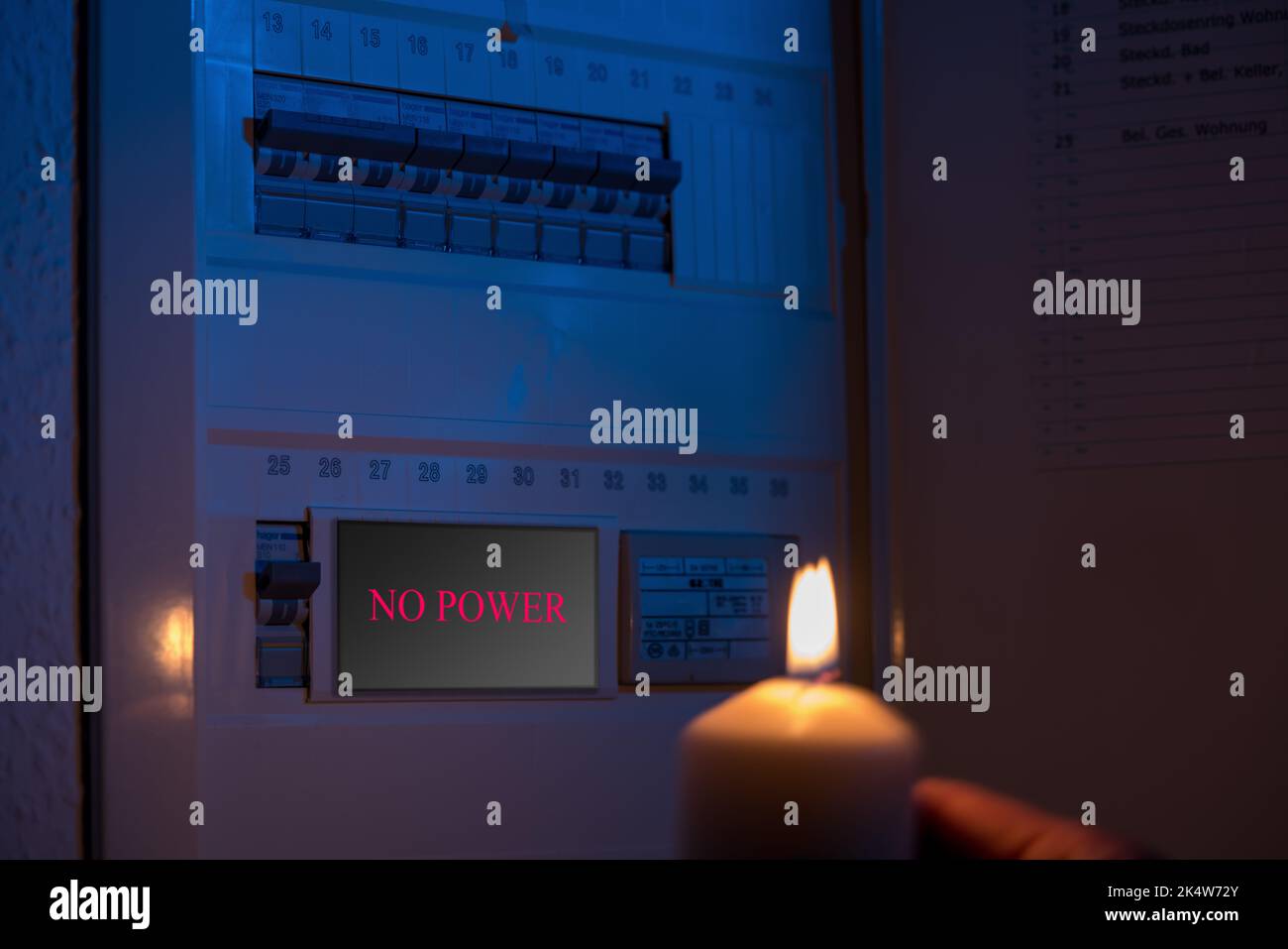 Electrical switch box panel with the text "no power" and burning candle ...