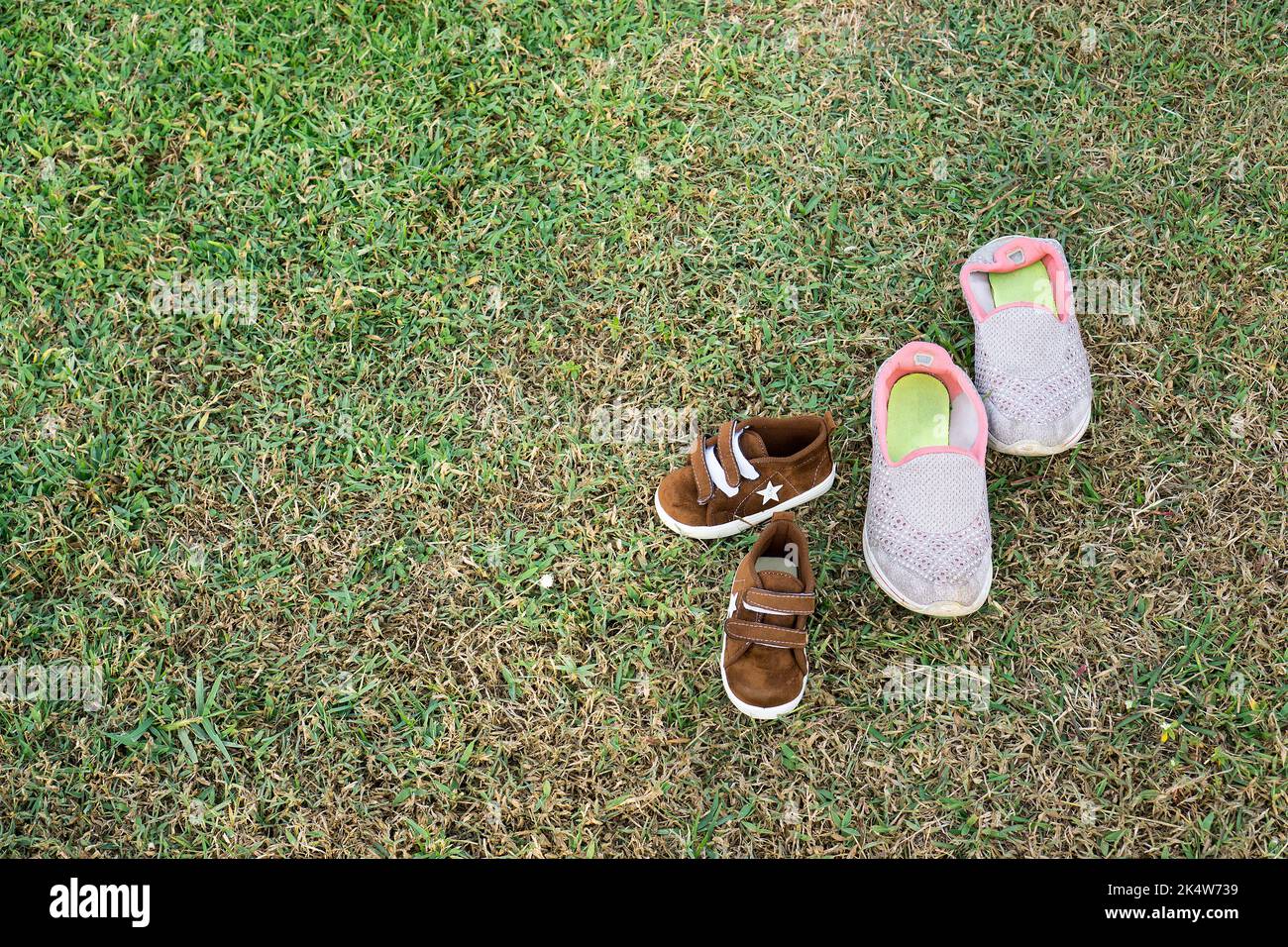 shoes of a mother and child left on the field to play together Stock ...