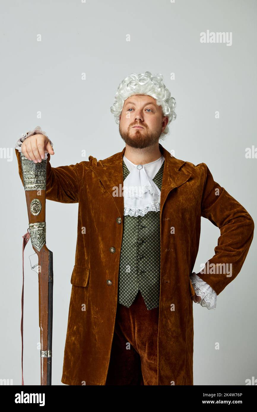Honor. Studio shot of young man in image of medieval person in vintage ...