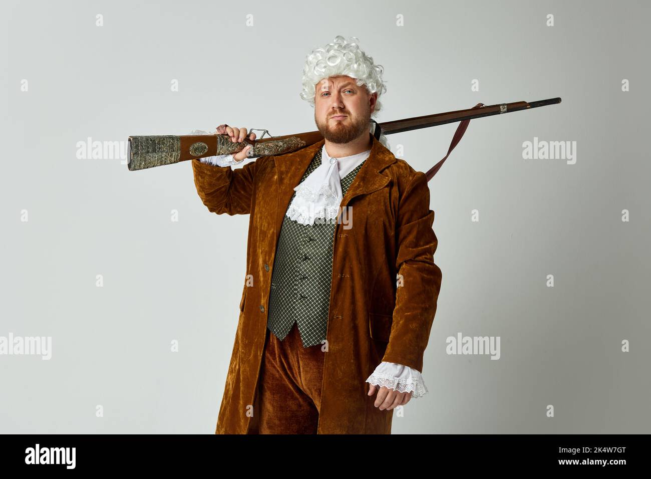 Serious young man in image of medieval person in vintage brown hunting ...