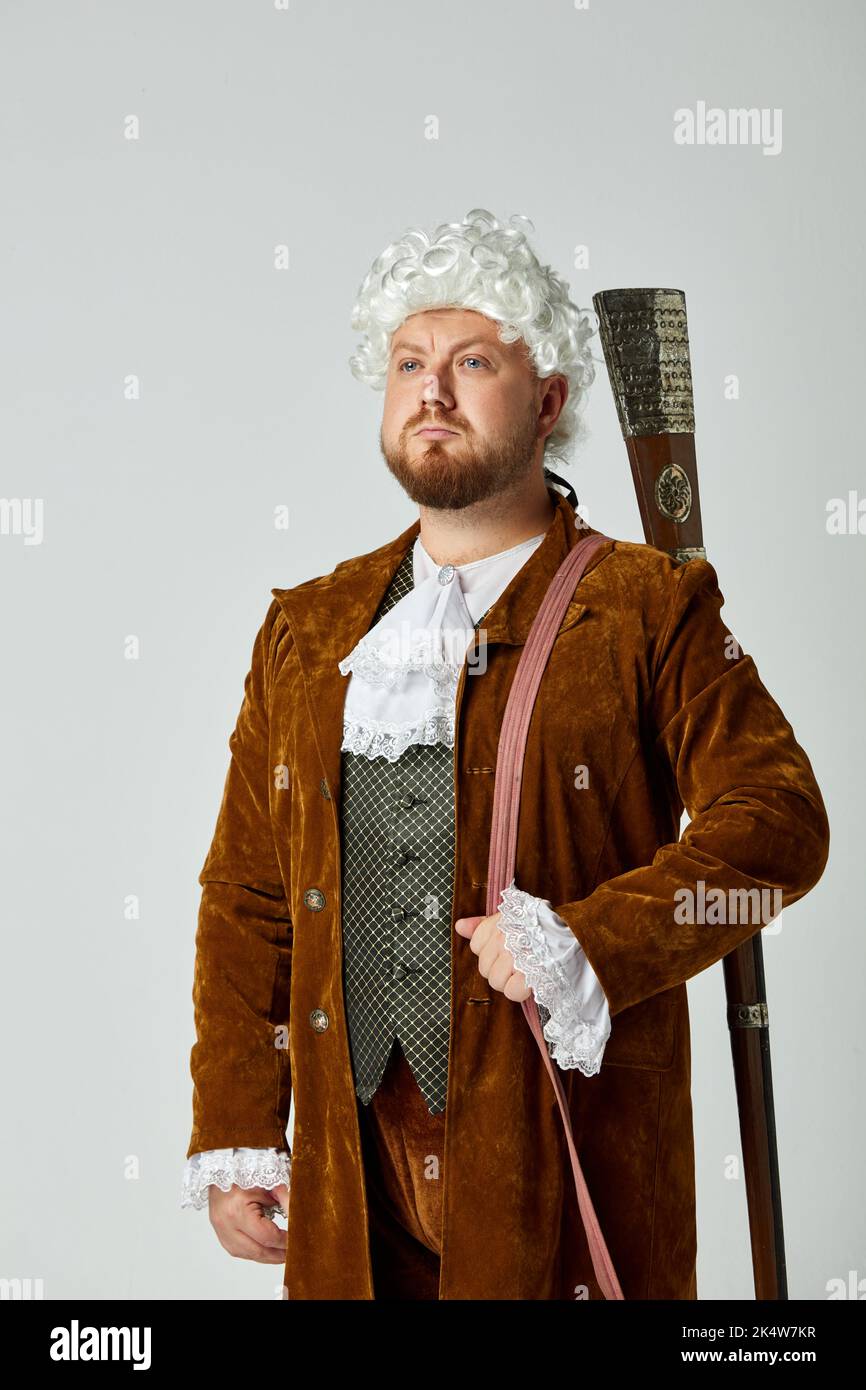 Studio shot of young man in image of medieval person in vintage brown ...