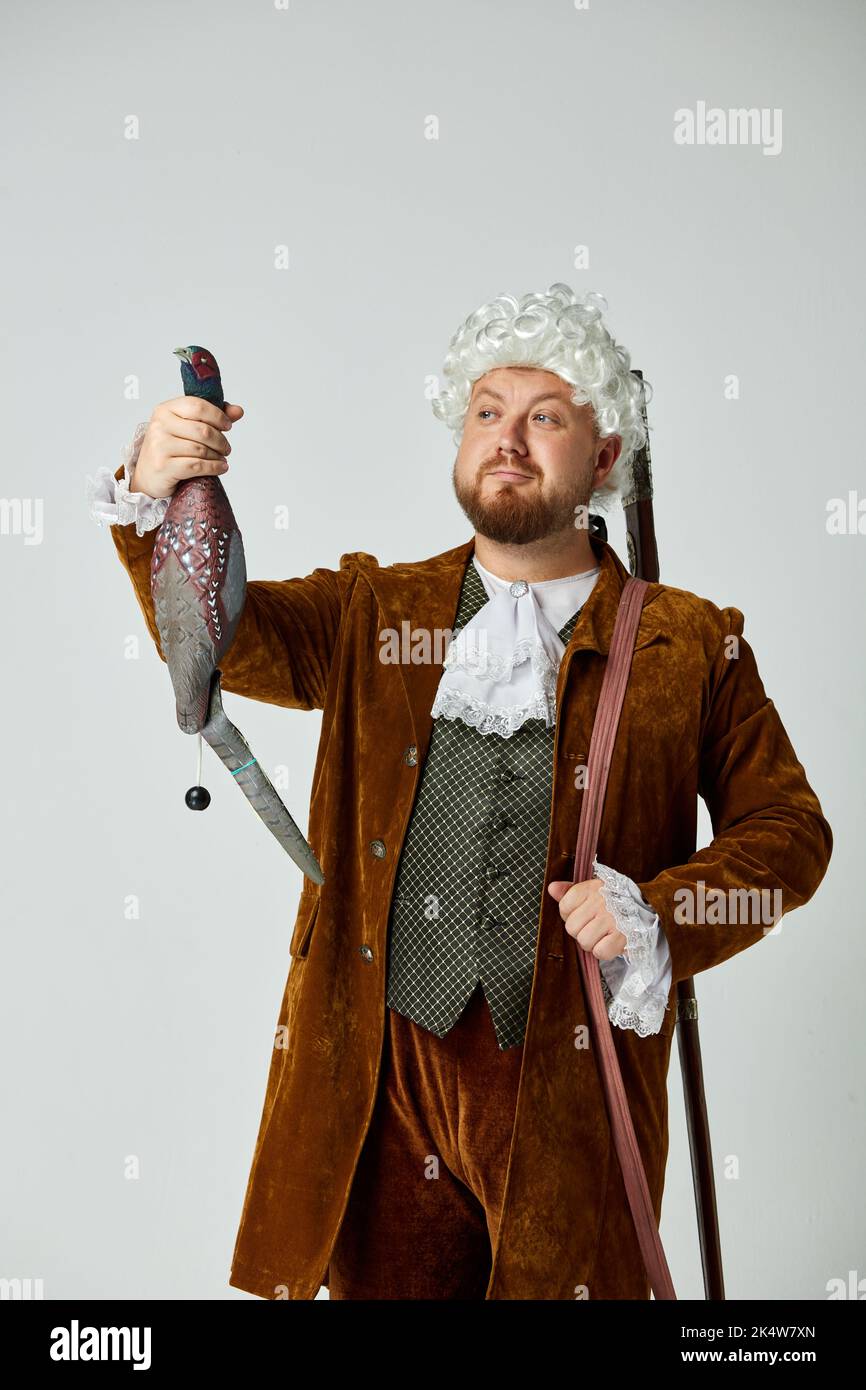 Studio shot of young man in image of medieval person in vintage brown ...