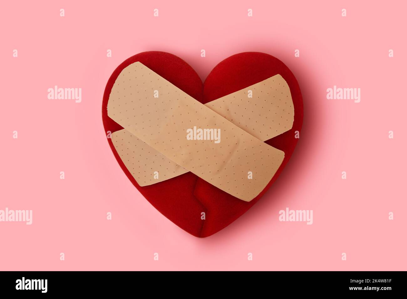 Broken heart with wound plaster- Concept of love and care Stock Photo ...