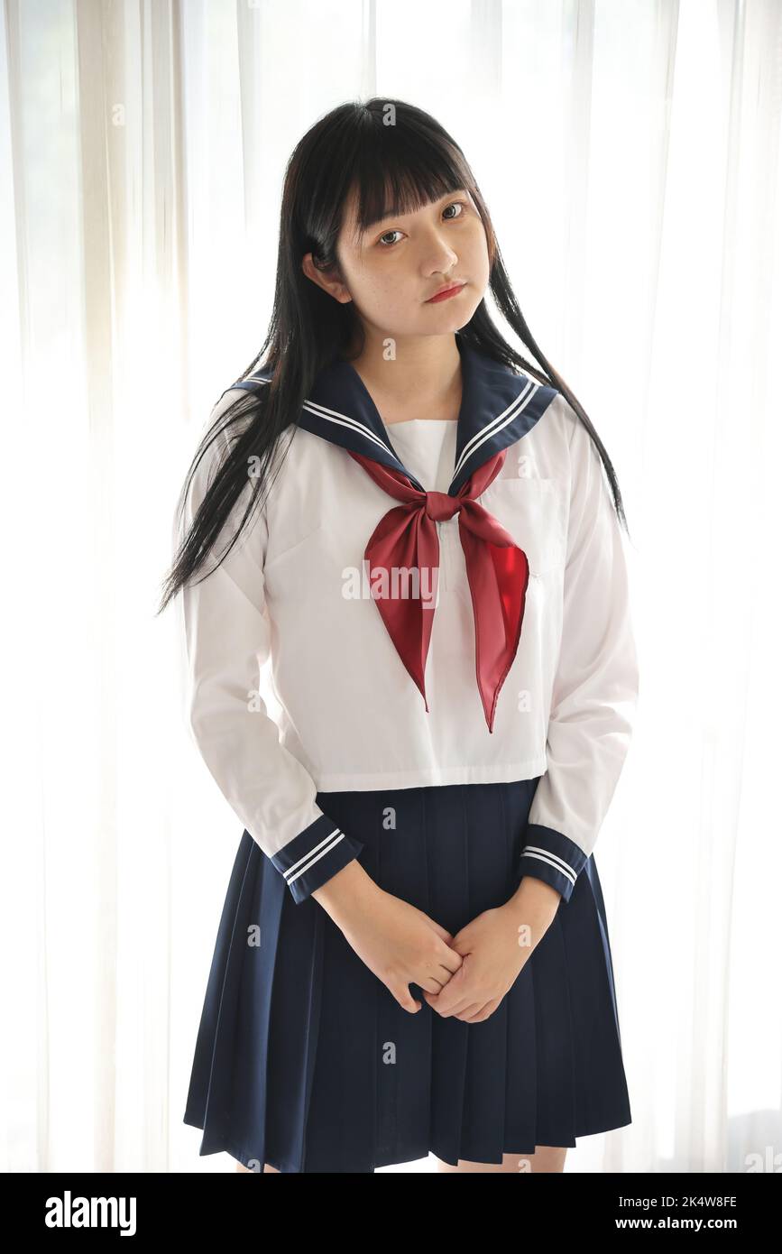 Asian High School Girls student looking at camera in white room Stock Photo - Alamy