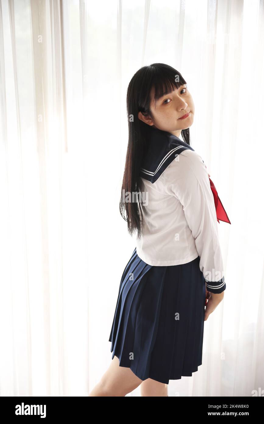 Asian High School Girls student looking at camera in white room Stock ...