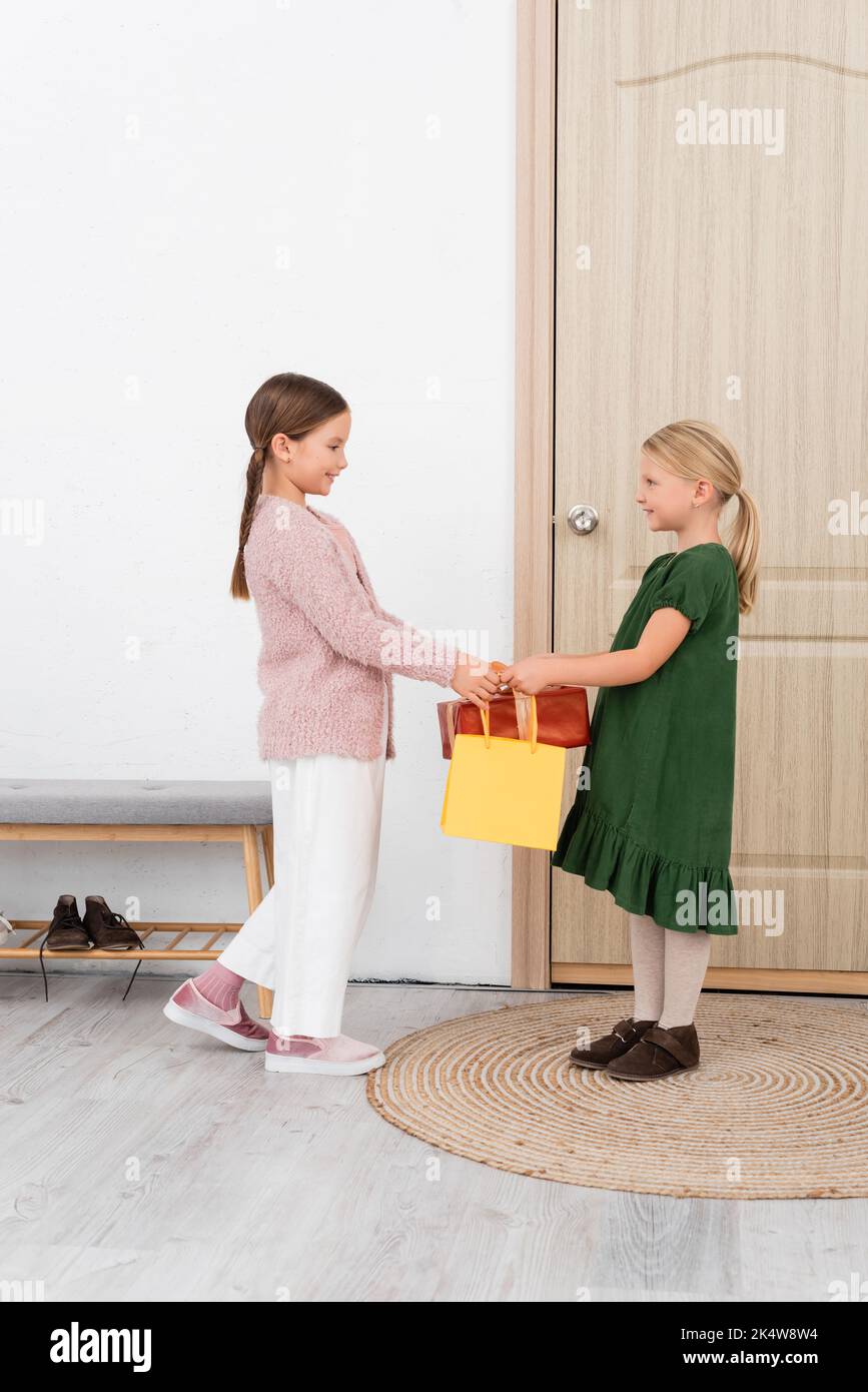 Cute girls giving friend present hi-res stock photography and images ...