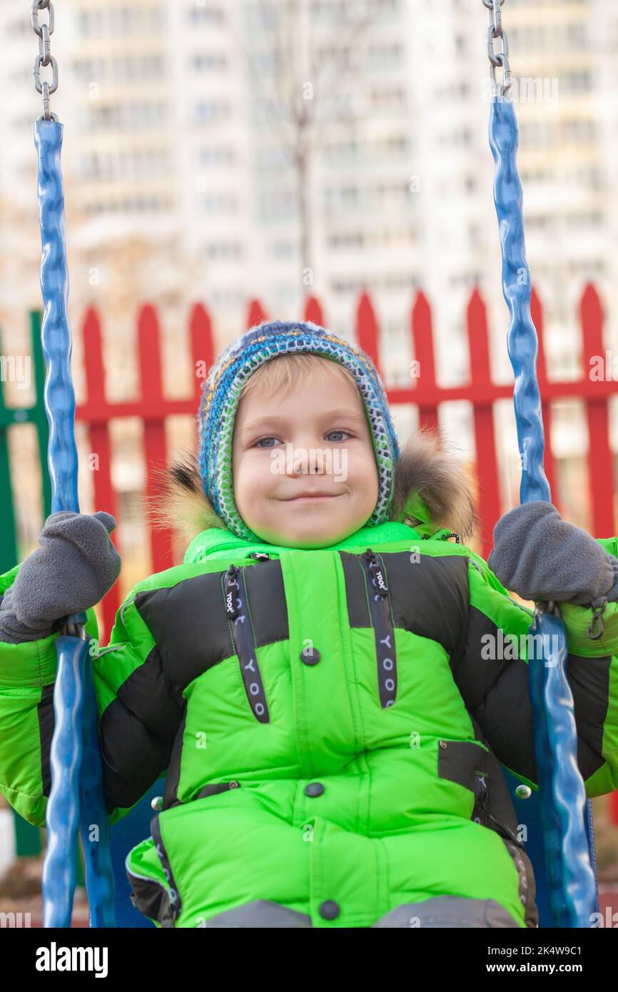 Adorable boy having fun on a swing on autumn day Stock Photo - Alamy