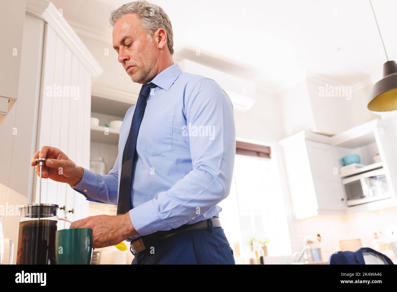 Happy caucasian man standing in kitchen and preparing coffee Stock ...