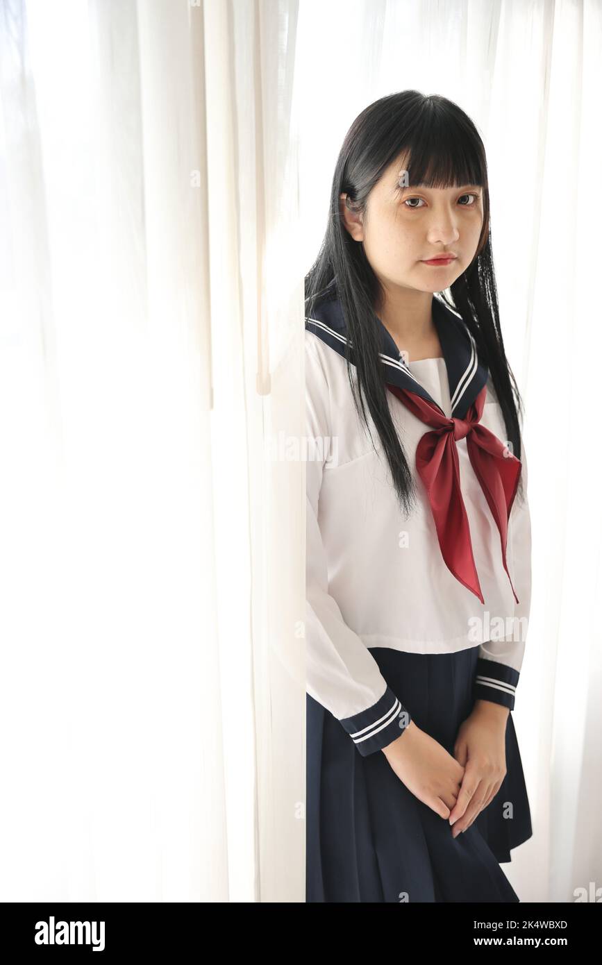 Asian High School Girls student looking at camera in white room Stock ...