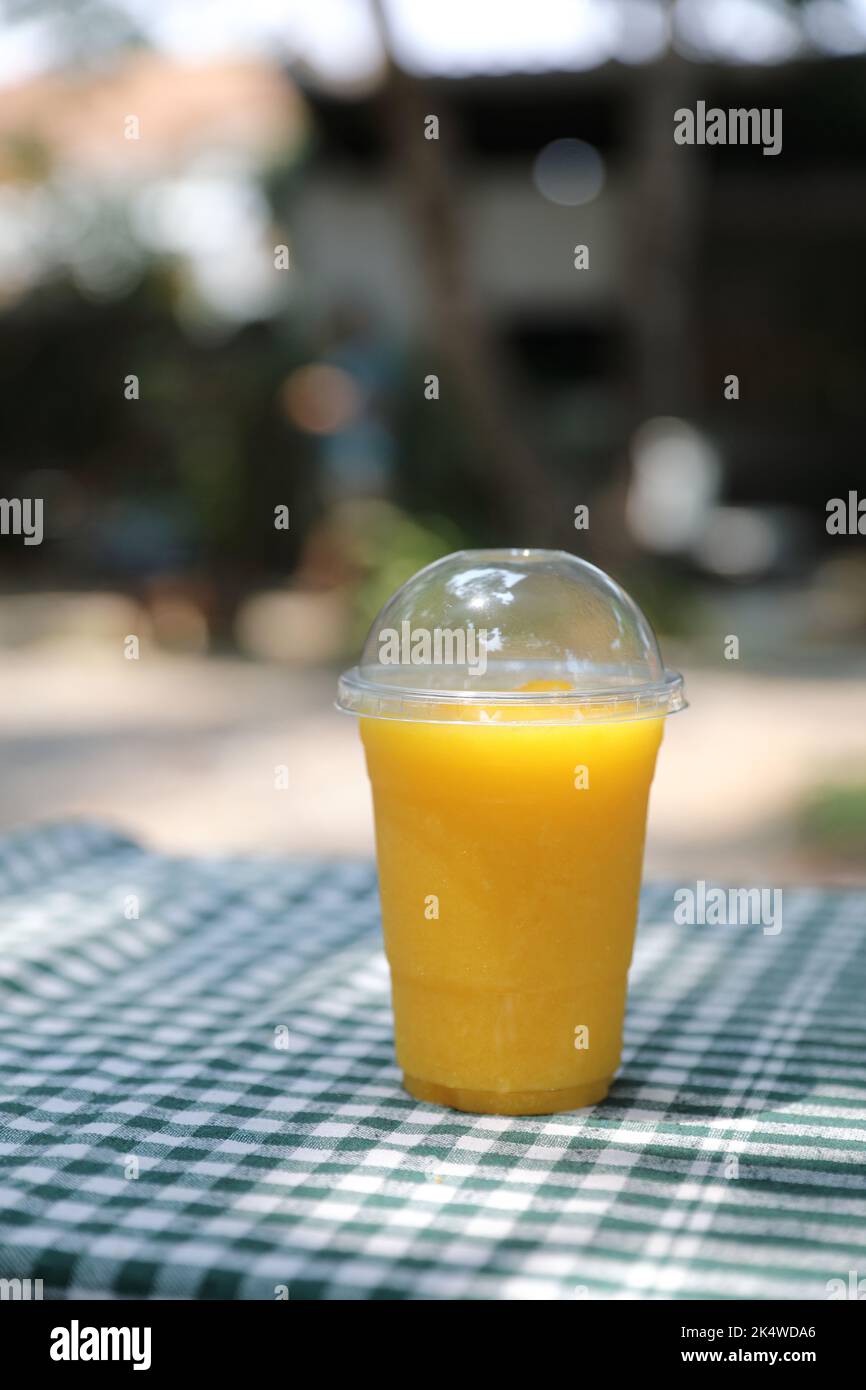 Mango smoothie milk shake with take out glass Stock Photo - Alamy