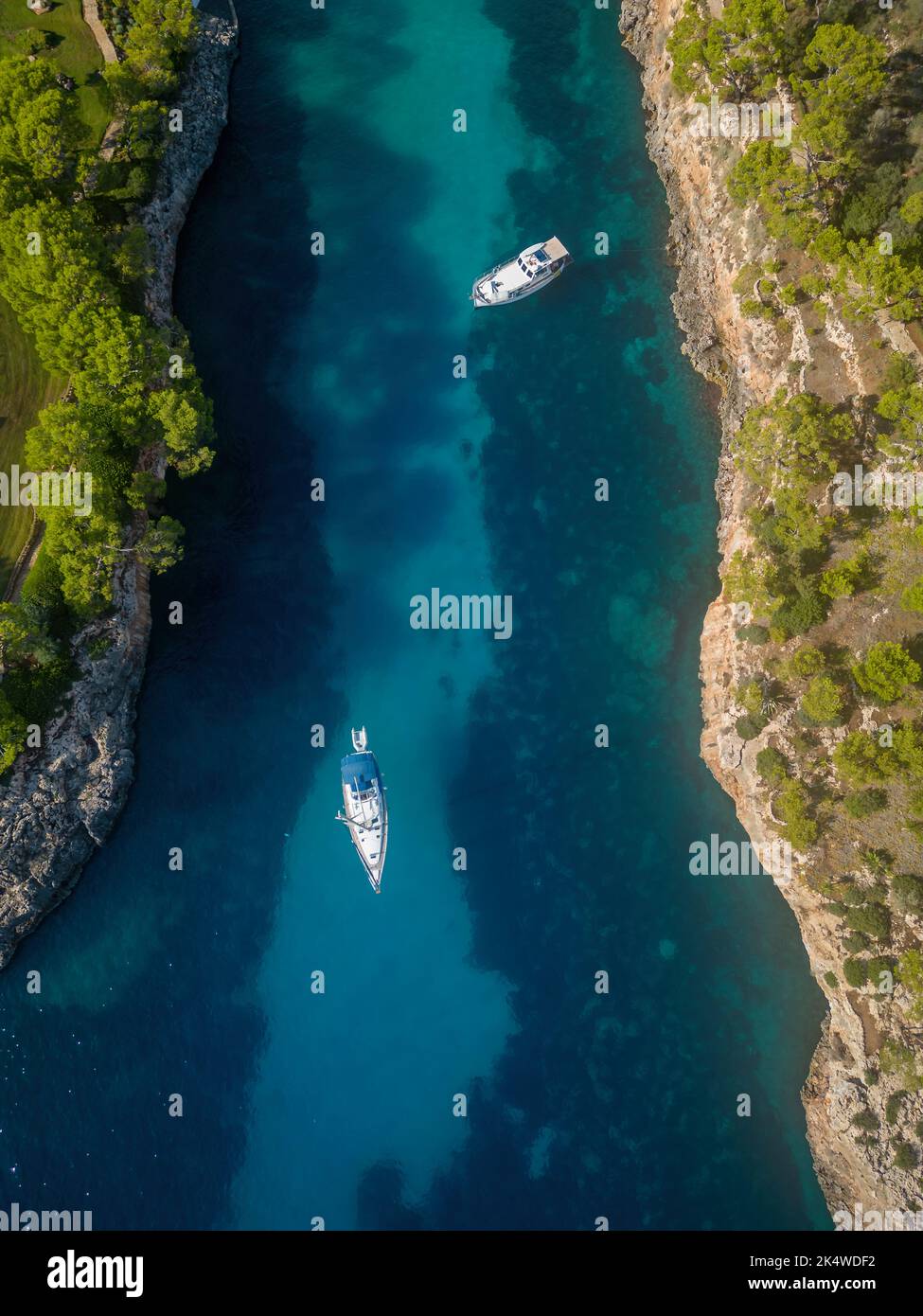 Aerial view of two boats in a coastal bay, Cala Mitjana, Majorca, Spain ...