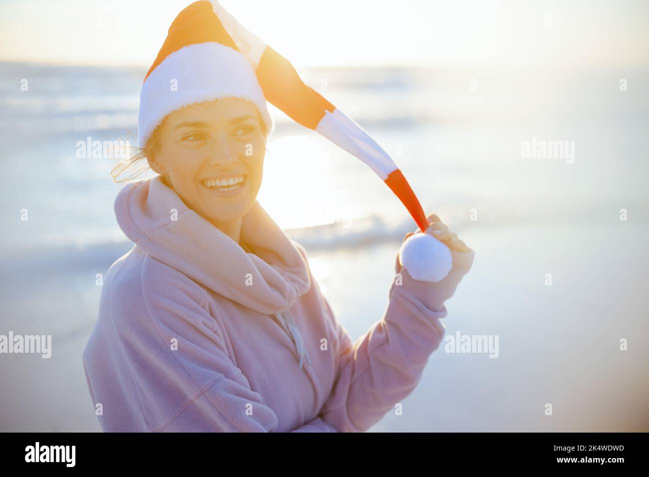 smiling modern 40 years old woman in cosy sweater with striped ...