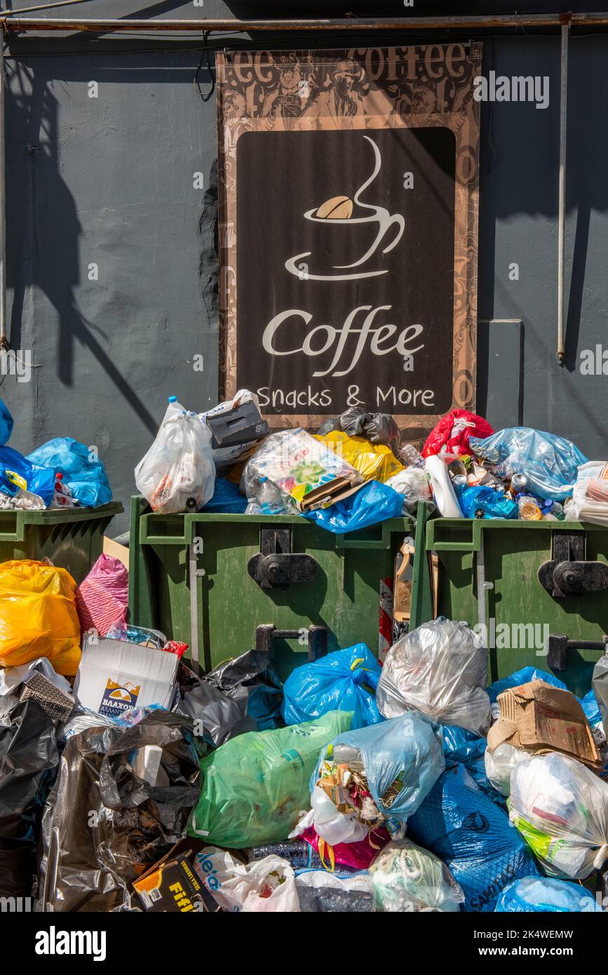 bags of rubbish piled up outside of a coffee shop in overflowing ...