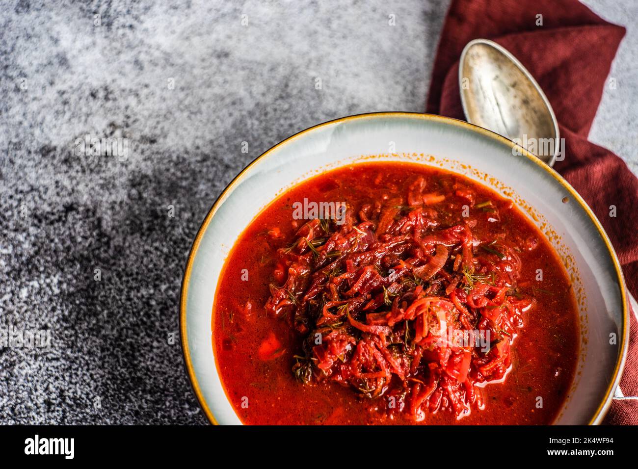 Overhead view of a bowl of traditional Ukrainian beetroot soup (borscht ...