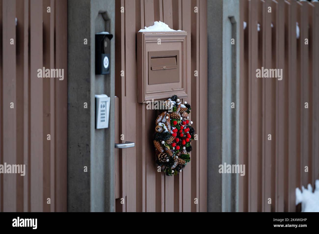 Christmas wreath on the gate at the entrance of the residential house ...