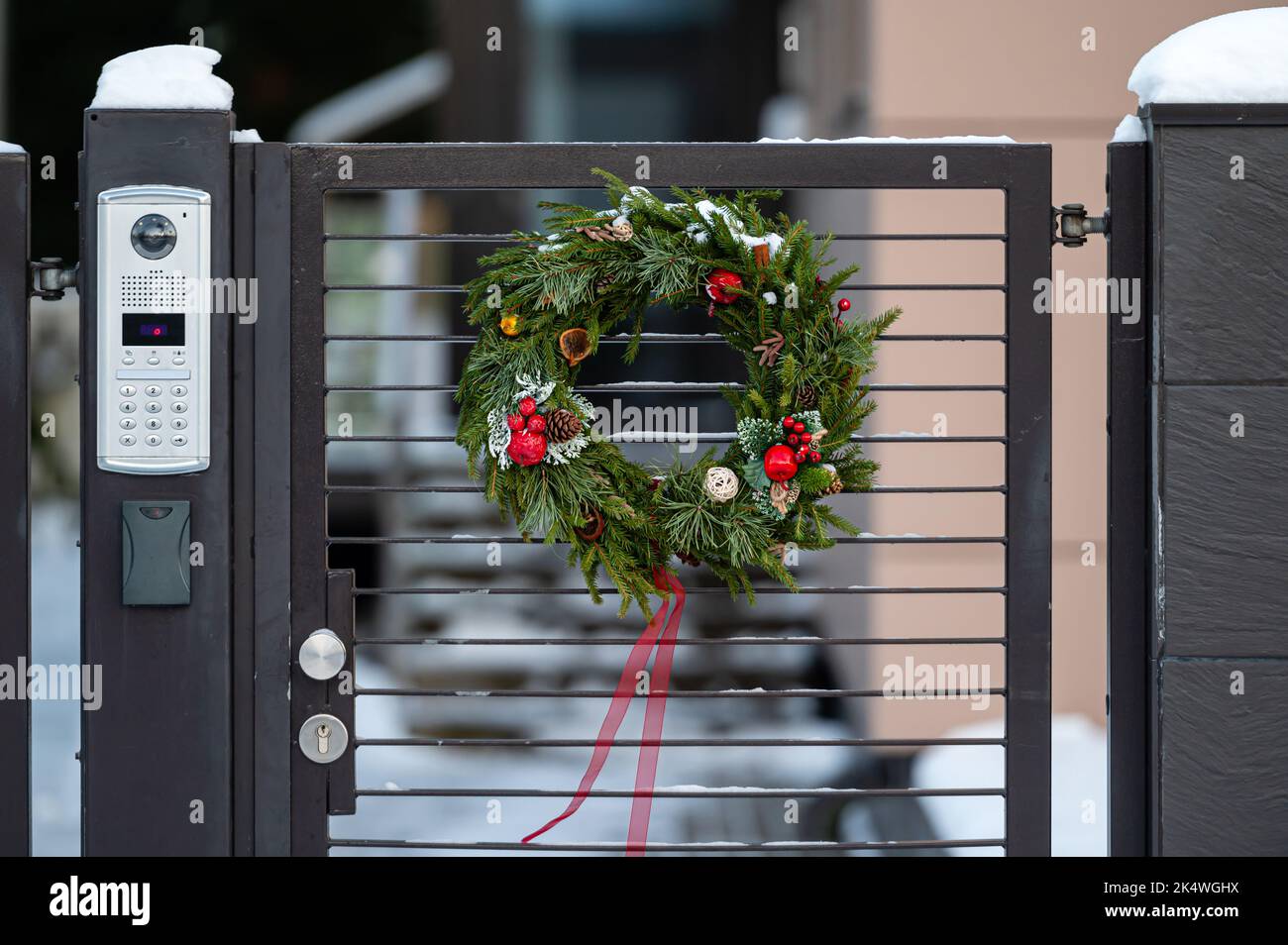Christmas wreath on a metal gate at the entrance of a residential ...