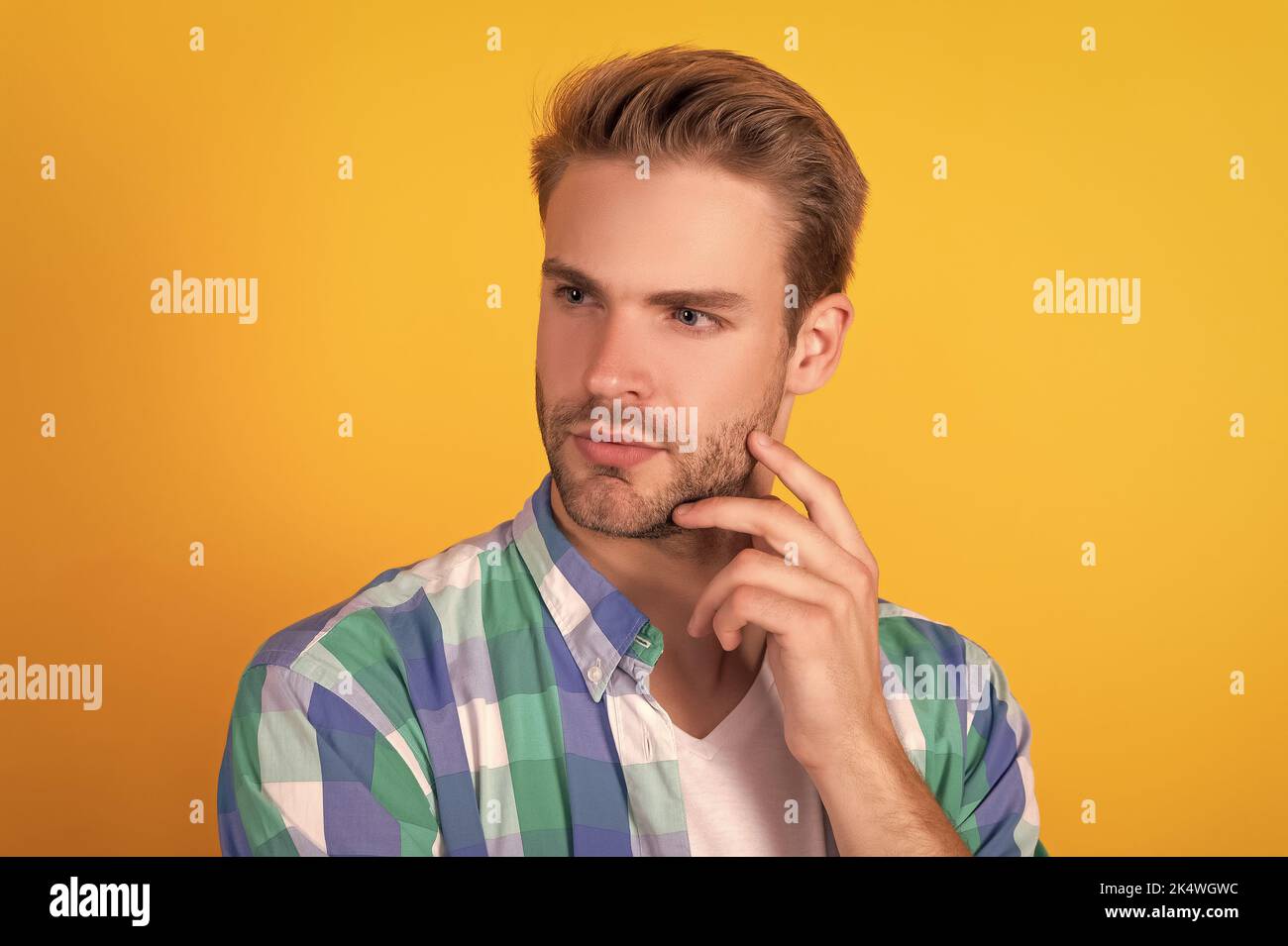 So serious. Mans portrait yellow background. Portrait of guy with ...
