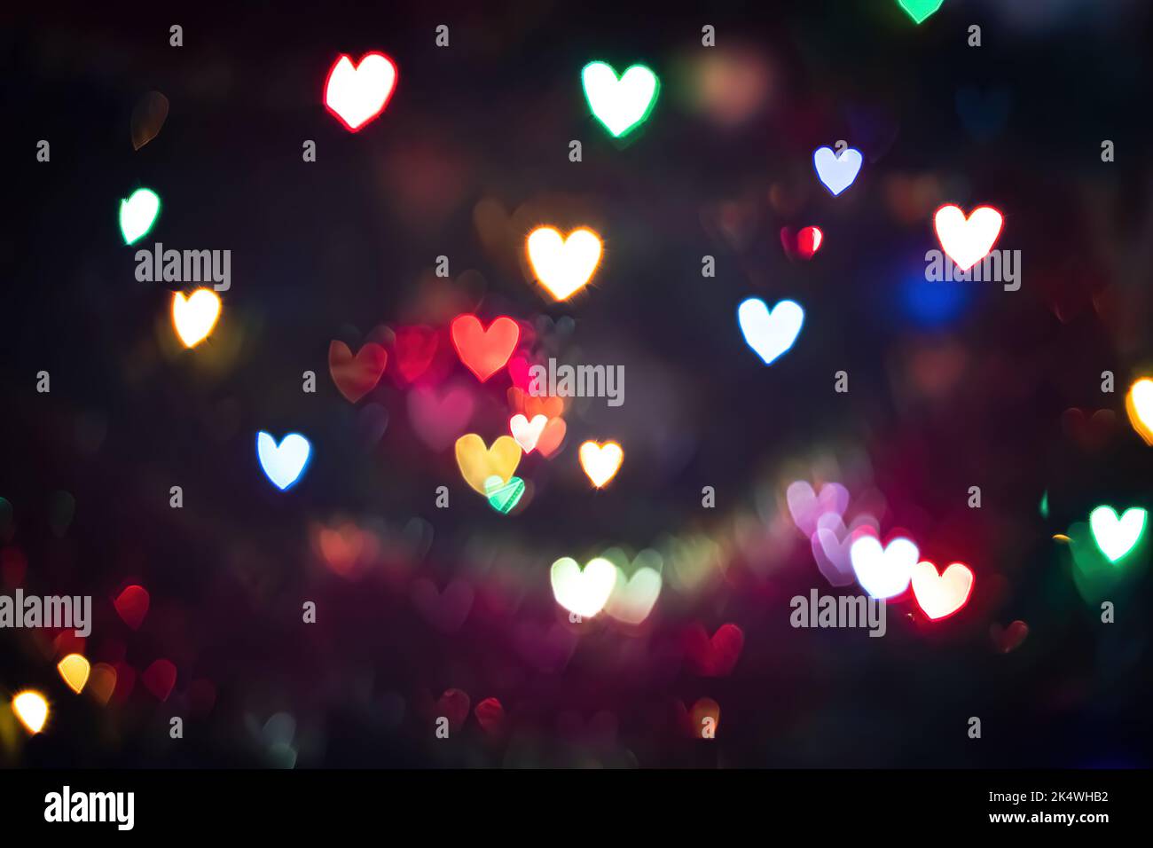 Multi-colored lights in shape of hearts. Blurred bokeh background for ...