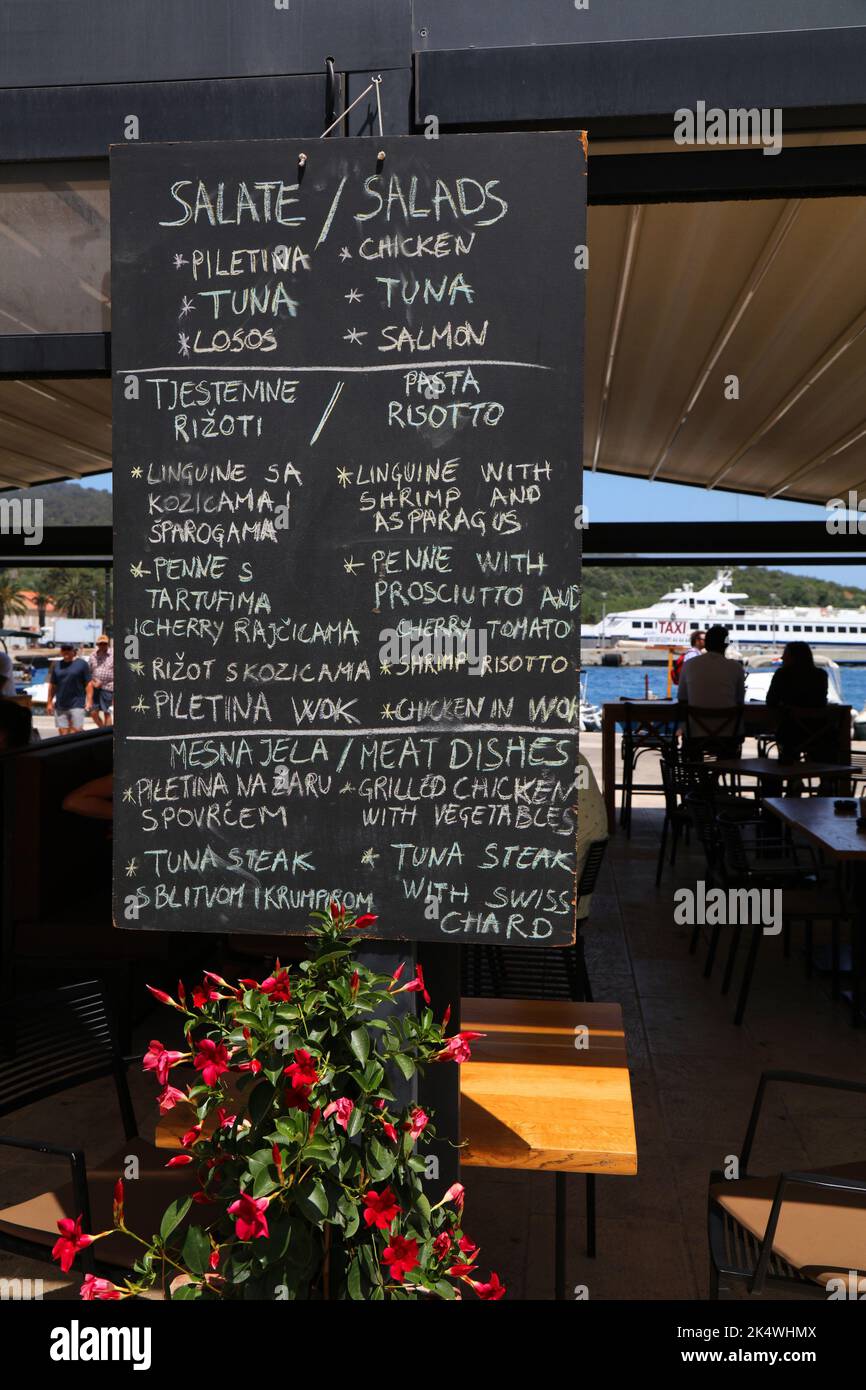 VIS, CROATIA - JUNE 22, 2021: Croatian and English language menu in a ...