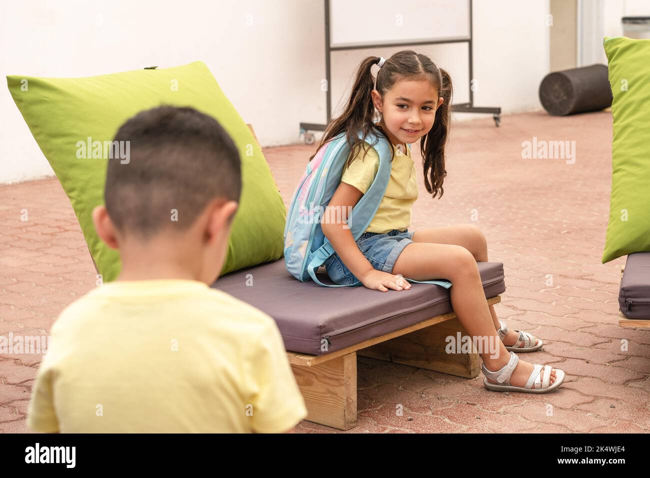 Two friends talking in the school corridor during a break. Kids playing ...