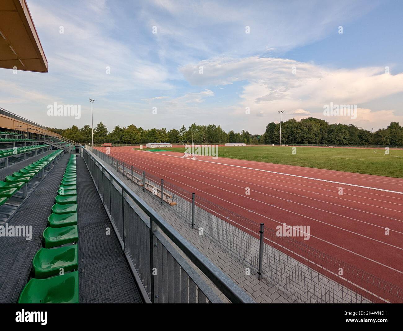 A beautiful shot of empty stadium seats by a running roads Stock Photo ...