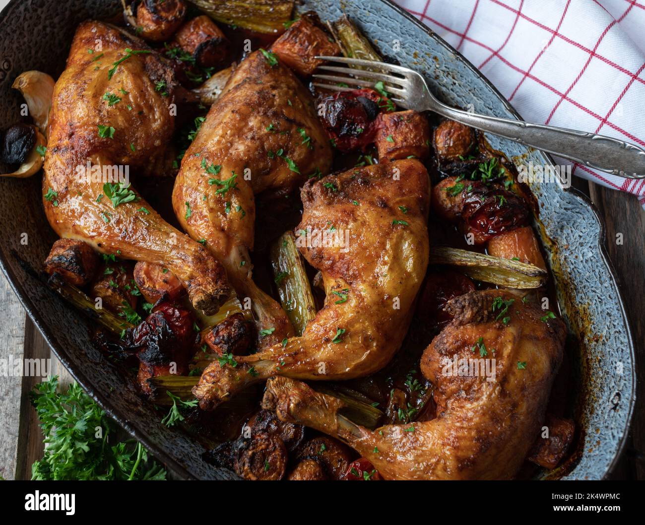 Braised chicken legs with root vegetables in a roasting pan Stock Photo ...