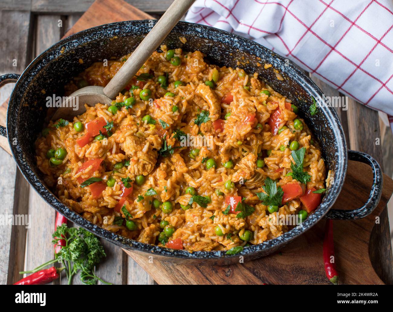 Serbian djuvec rice with chicken meat. Served in a rustic pot isolated ...