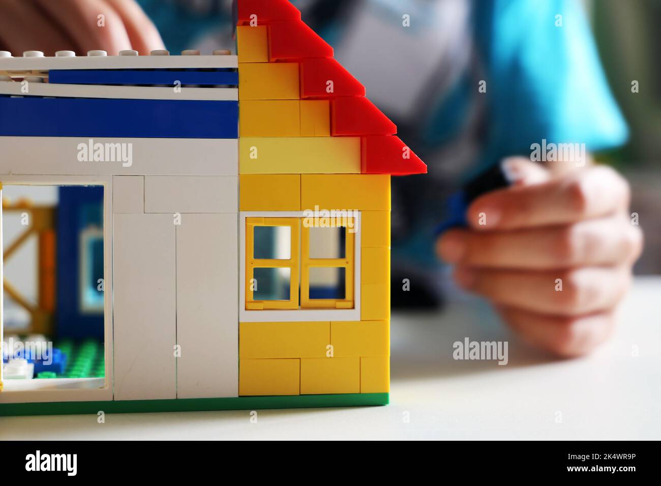 Boy builds a house with building blocks (Model released Stock Photo - Alamy