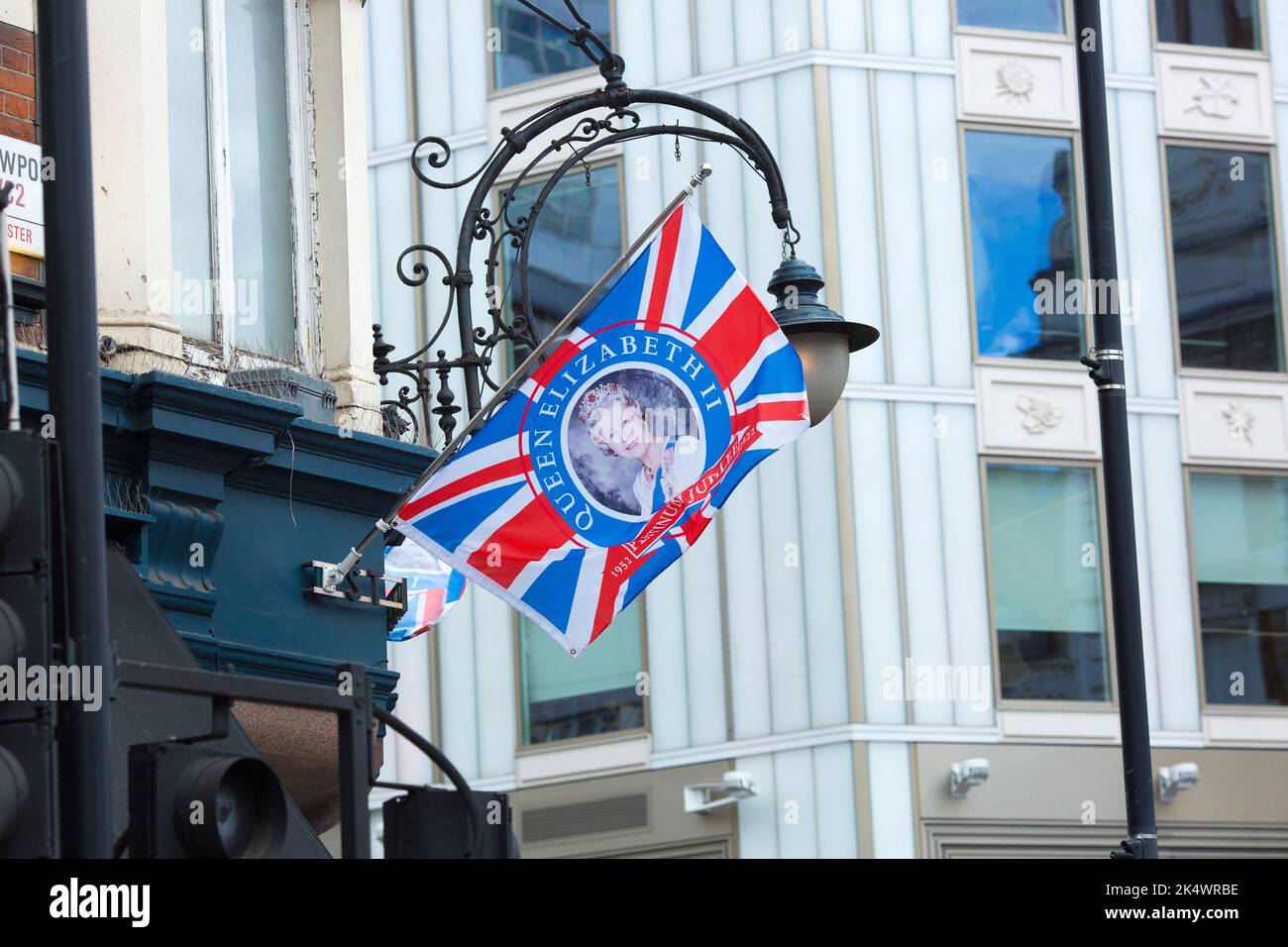 A Union flag featuring a portrait of Britain’s Queen Elizabeth II is ...