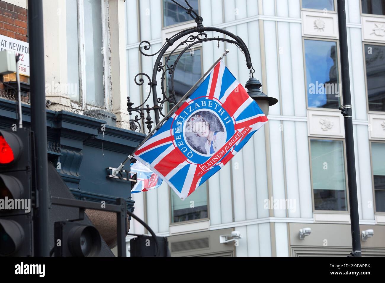 A Union flag featuring a portrait of Britain’s Queen Elizabeth II is ...