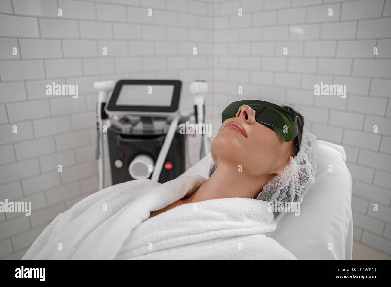 Woman is making cavitation rejuvenation skin treatment. Radio wave ...