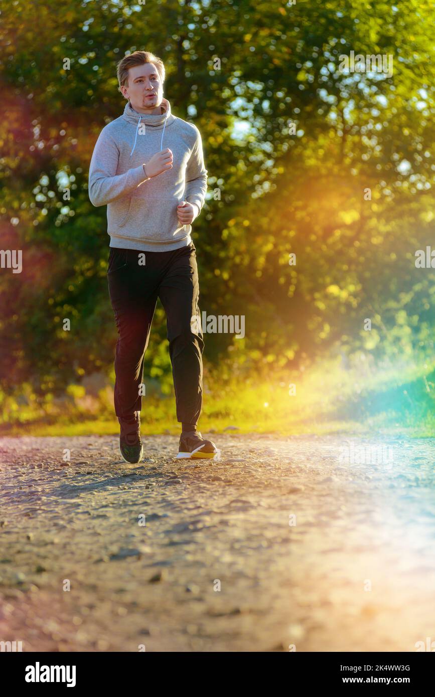 Running man jogging in rural nature at beautiful summer day. Sport ...