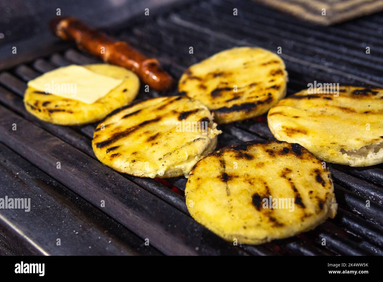 Close-up of some arepas with cheese and grilled chorizo. Typical food ...