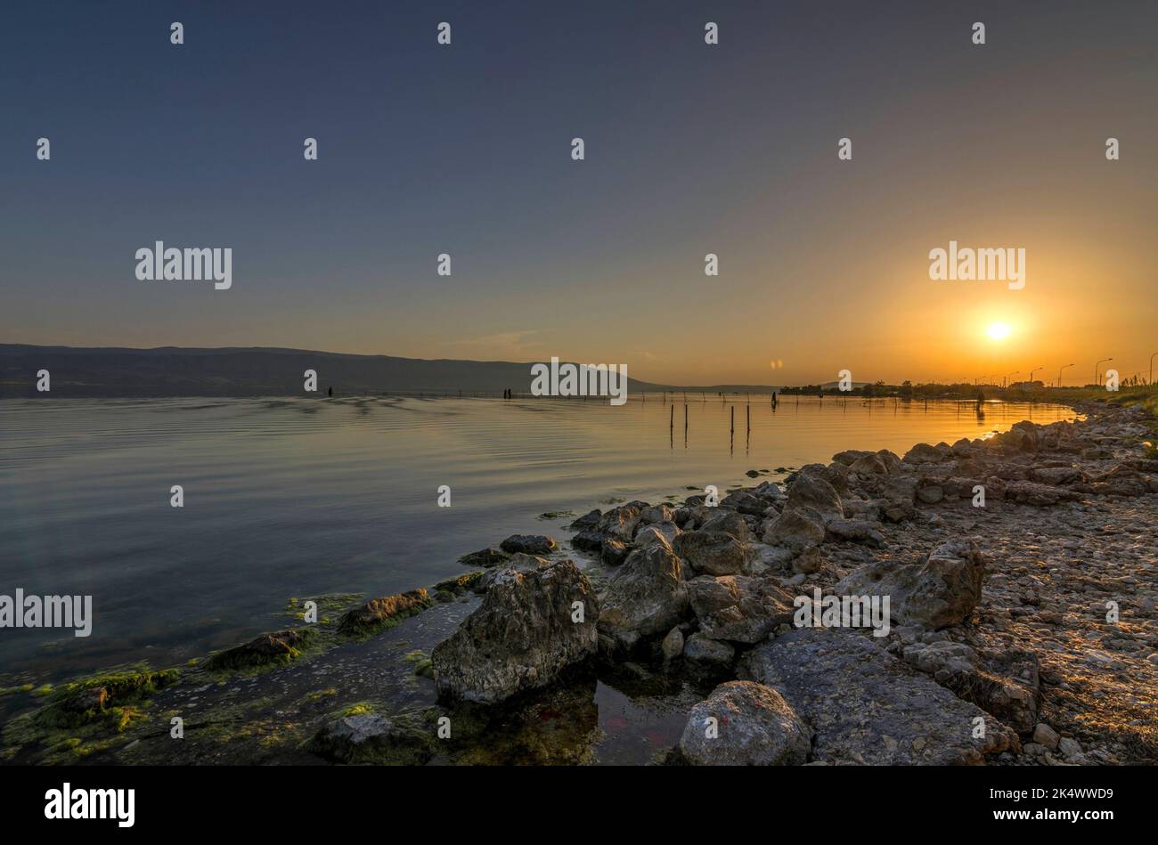 Lagoon landscape with sun setting over the lake Stock Photo - Alamy