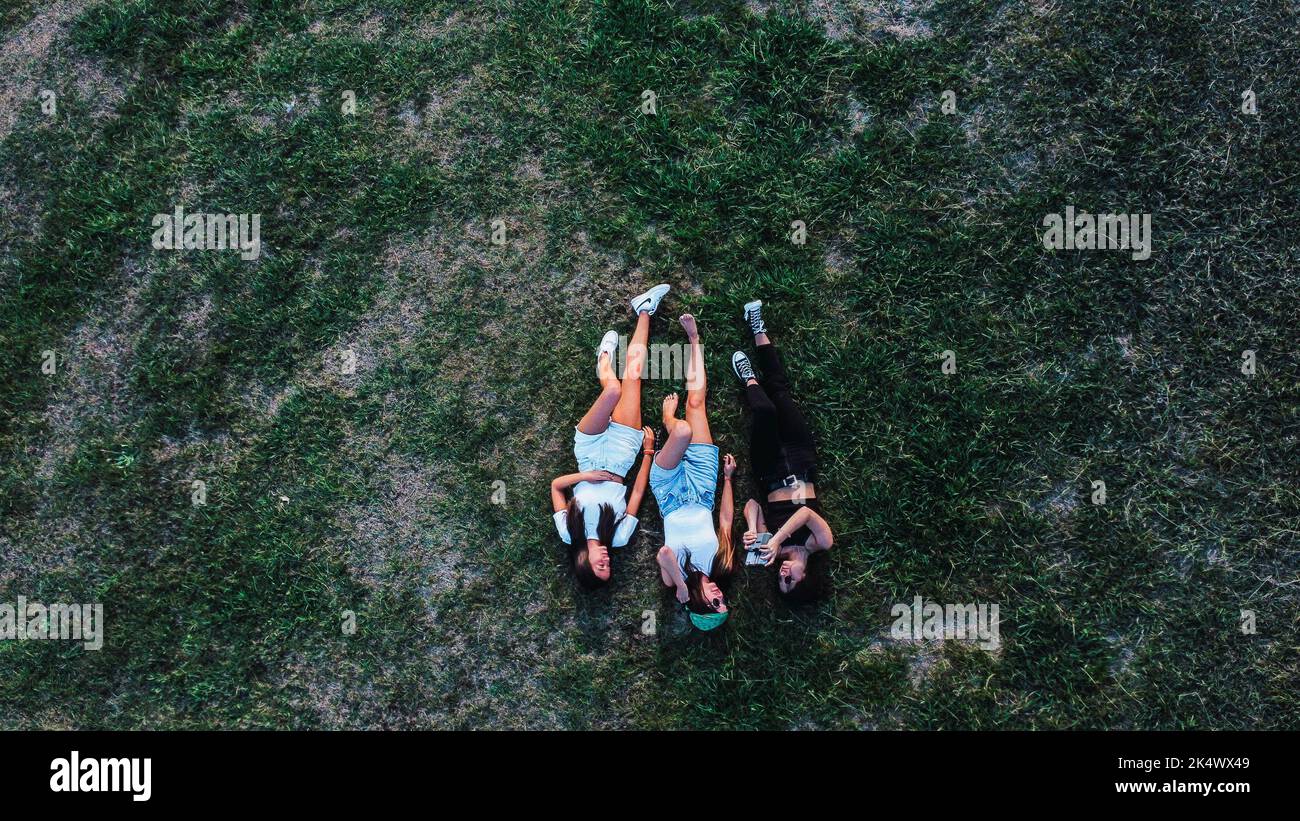 bird's eye view of three women lying on the grass Stock Photo - Alamy