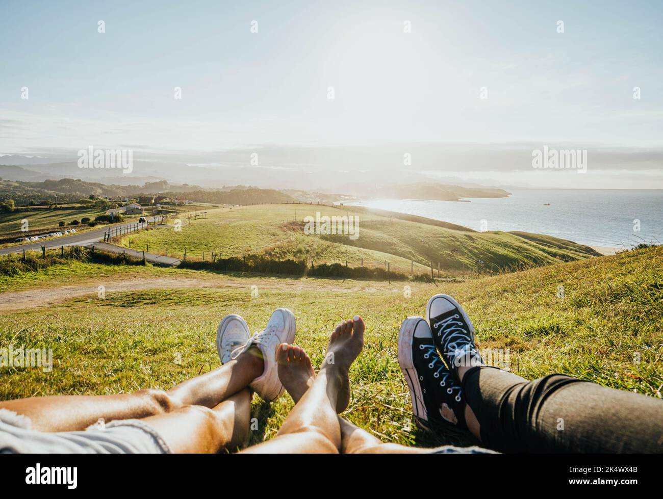 legs of three women against sunset on beach landscape Stock Photo - Alamy
