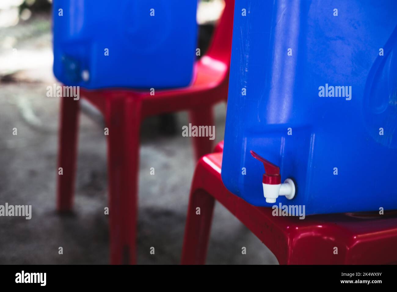 Slim, rectangular space saving blue container with faucet tap contains ...