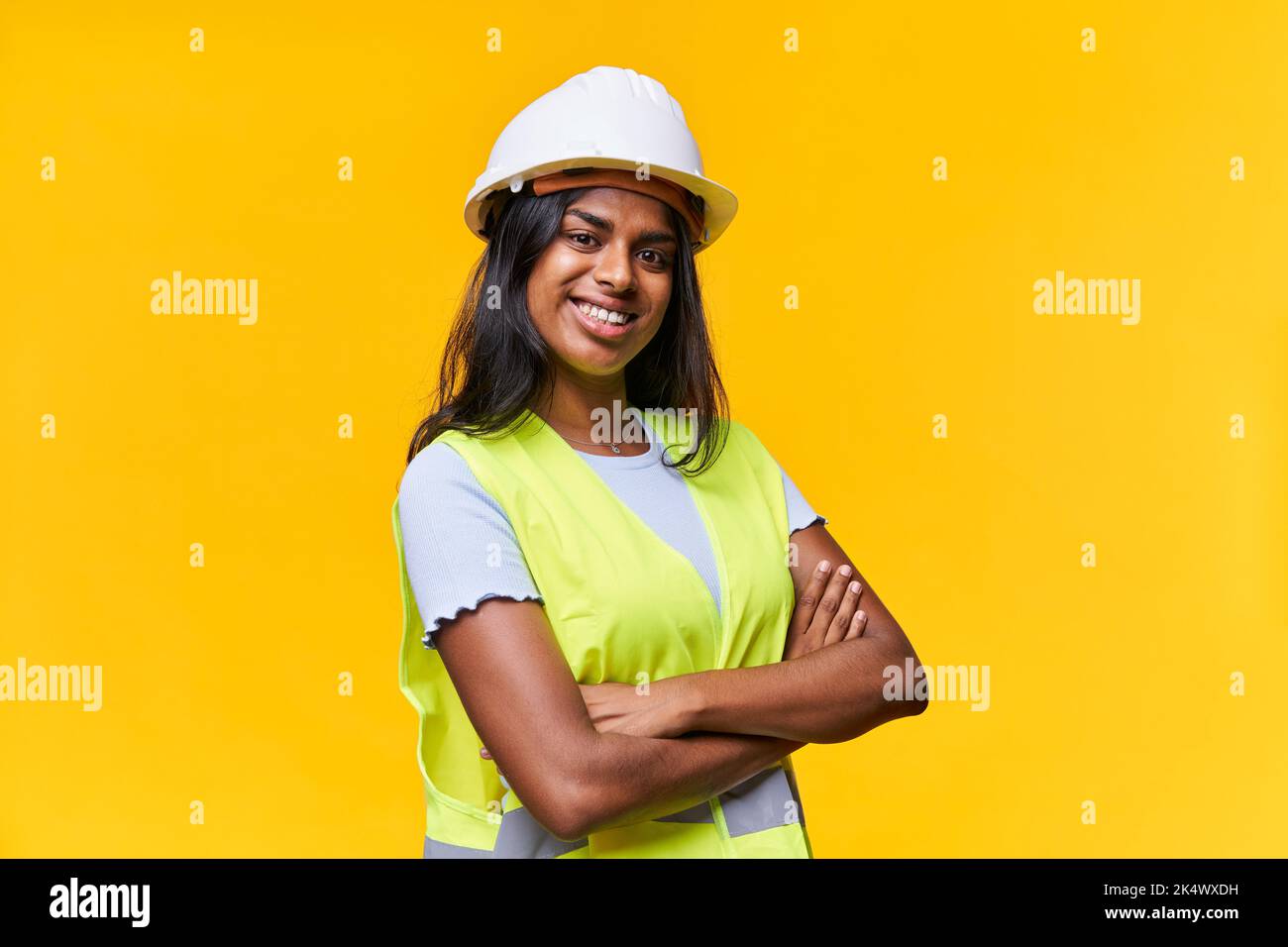 Positive young lady crossed arms, beaming smile wear protective ...