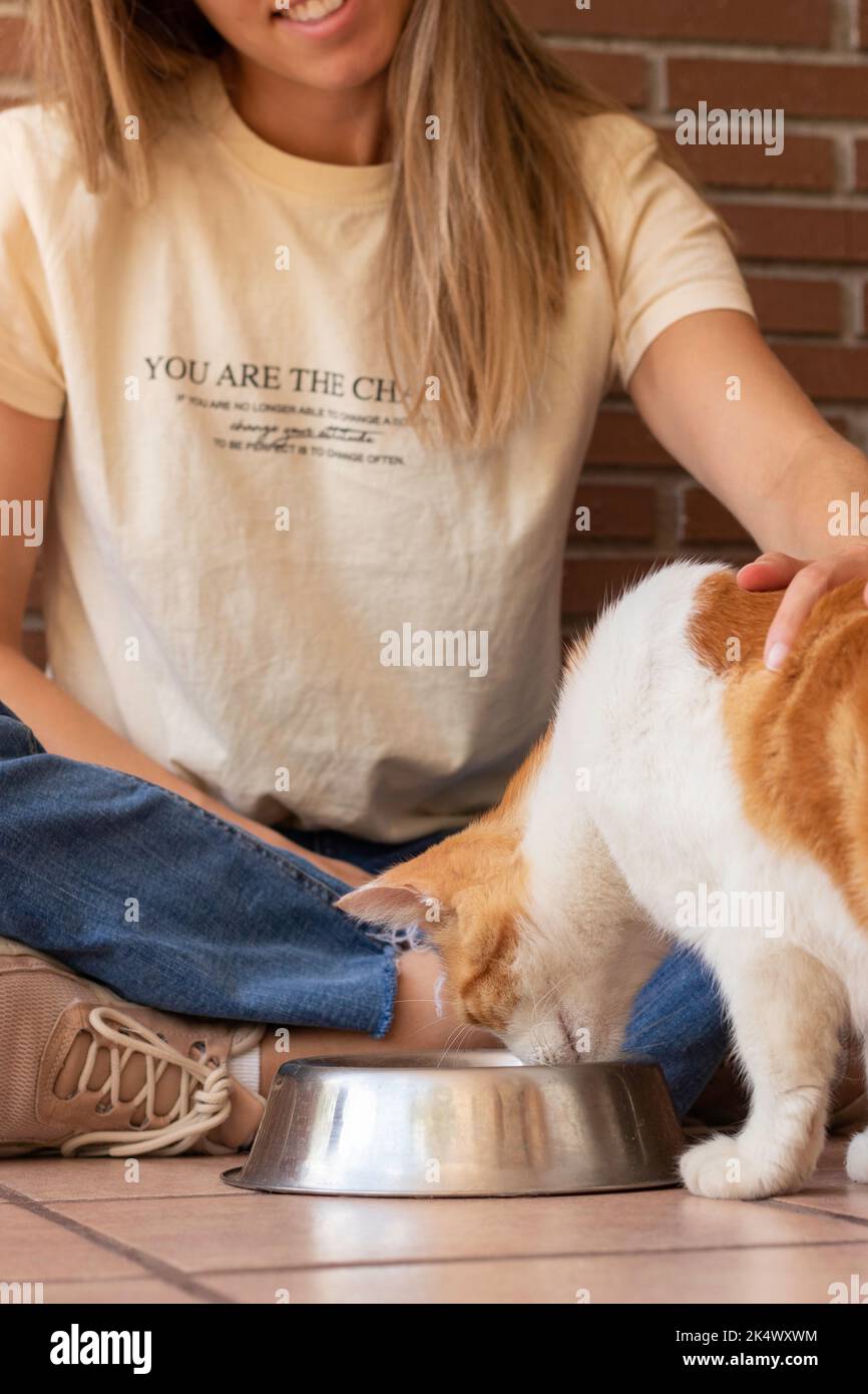 Vertical view of unrecognizable young woman smiling and sitting on the ...