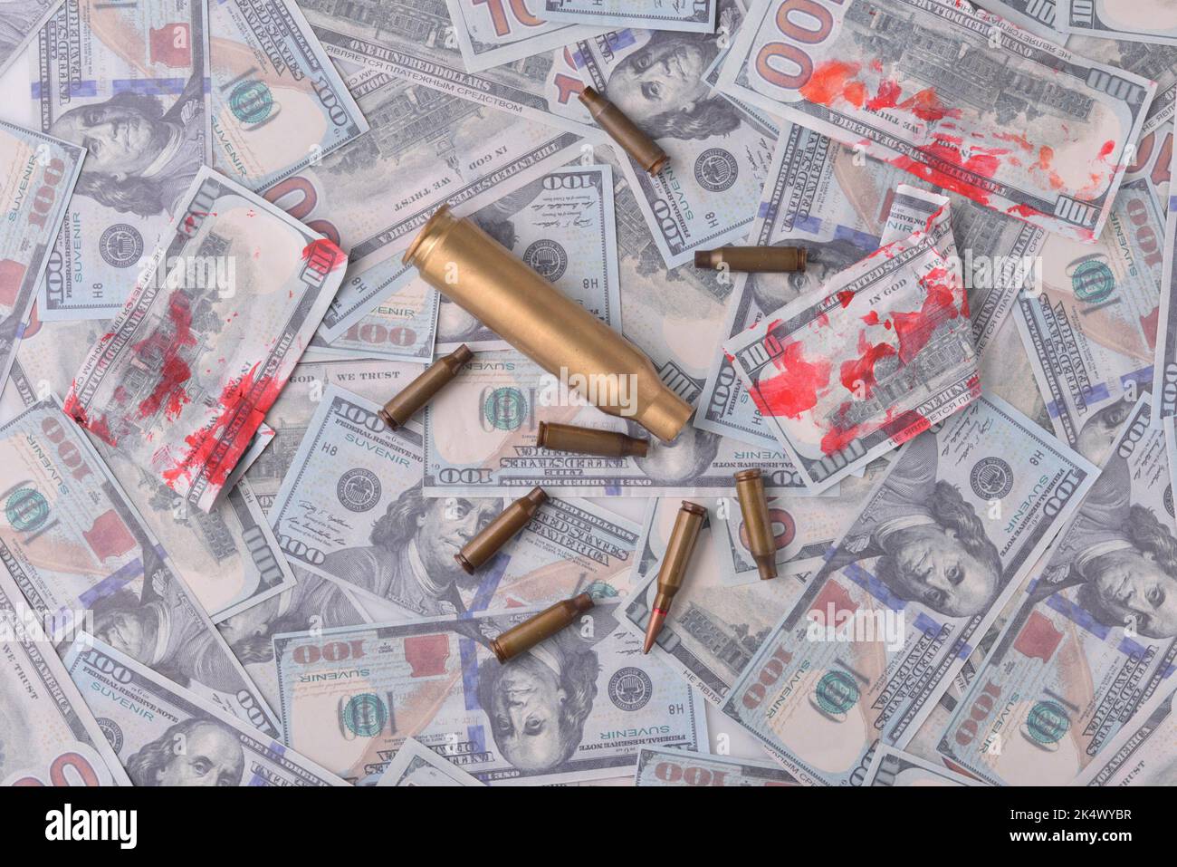 blood money of war. Cartridges with blood in dollar bills Stock Photo ...