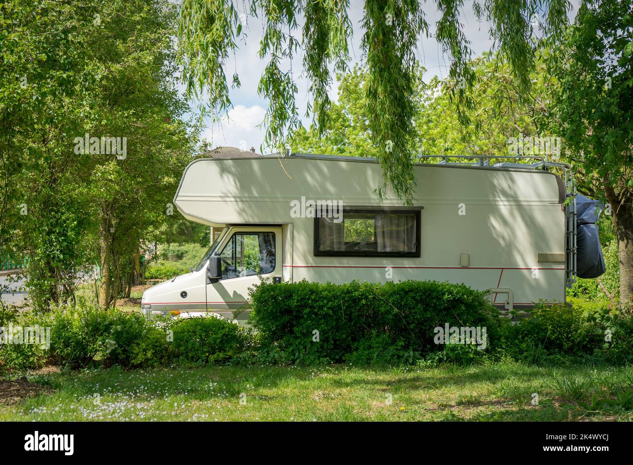 Motorhome parked between trees in the middle of nature Stock Photo - Alamy